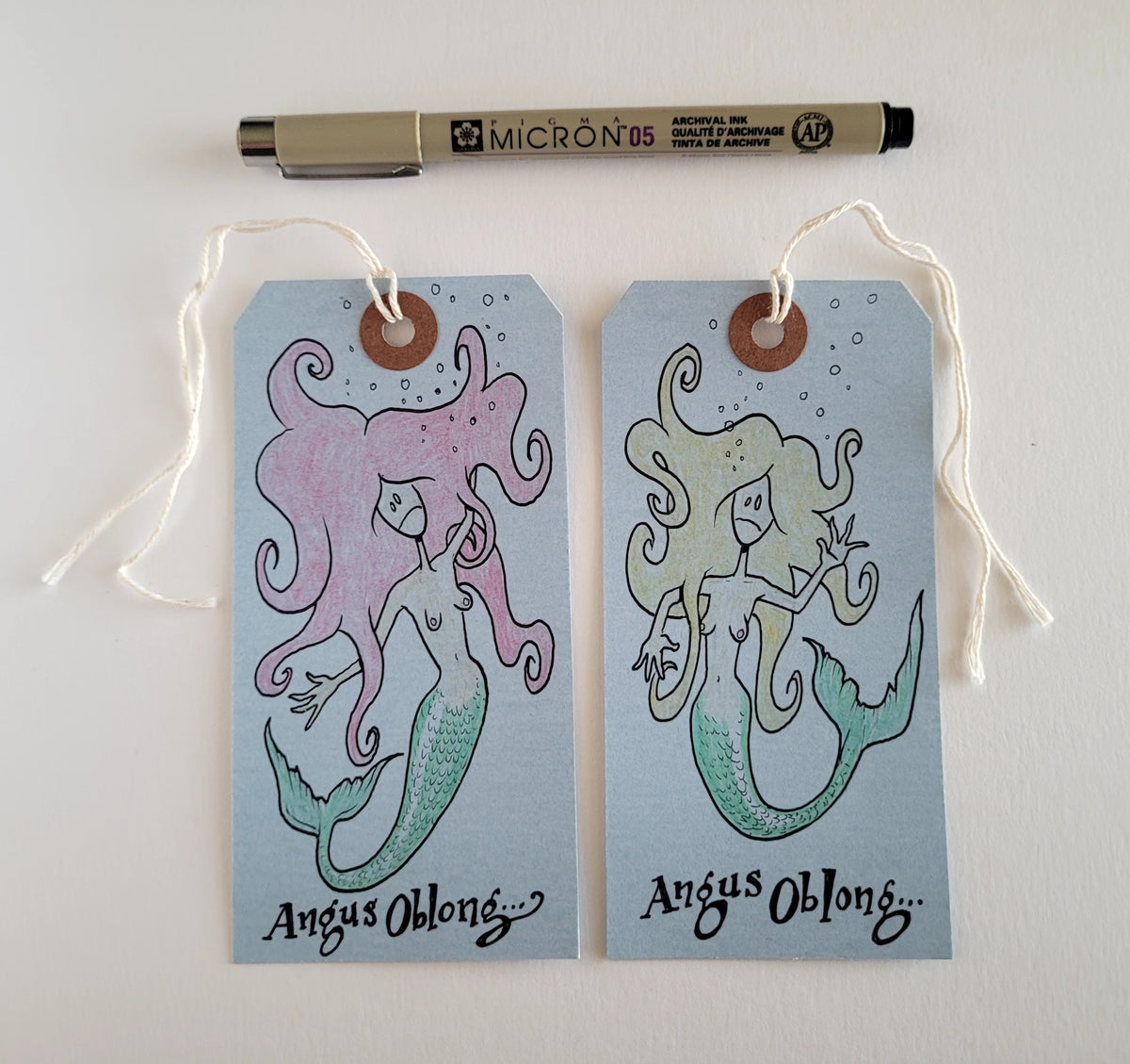 2 Dead Mermaids drawn on real Coroner's Toe Tags! – Angus Oblong.